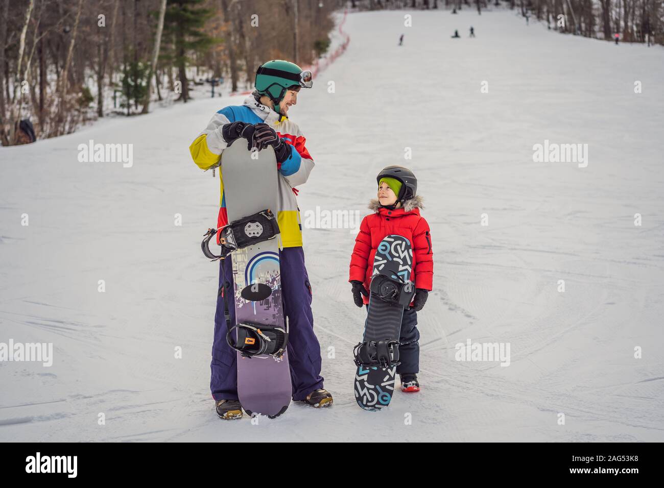 Snowboard instructor teaches a boy to snowboarding. Activities for ...