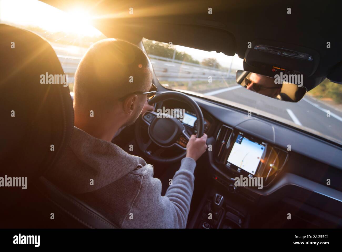 Man driving a car. Success in motion. Handsome young man driving a car ...