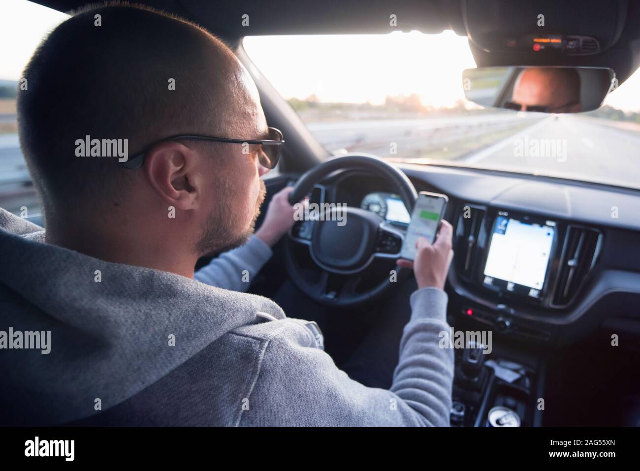 Man driving car using mobile phone texting message or calling. Driver ...