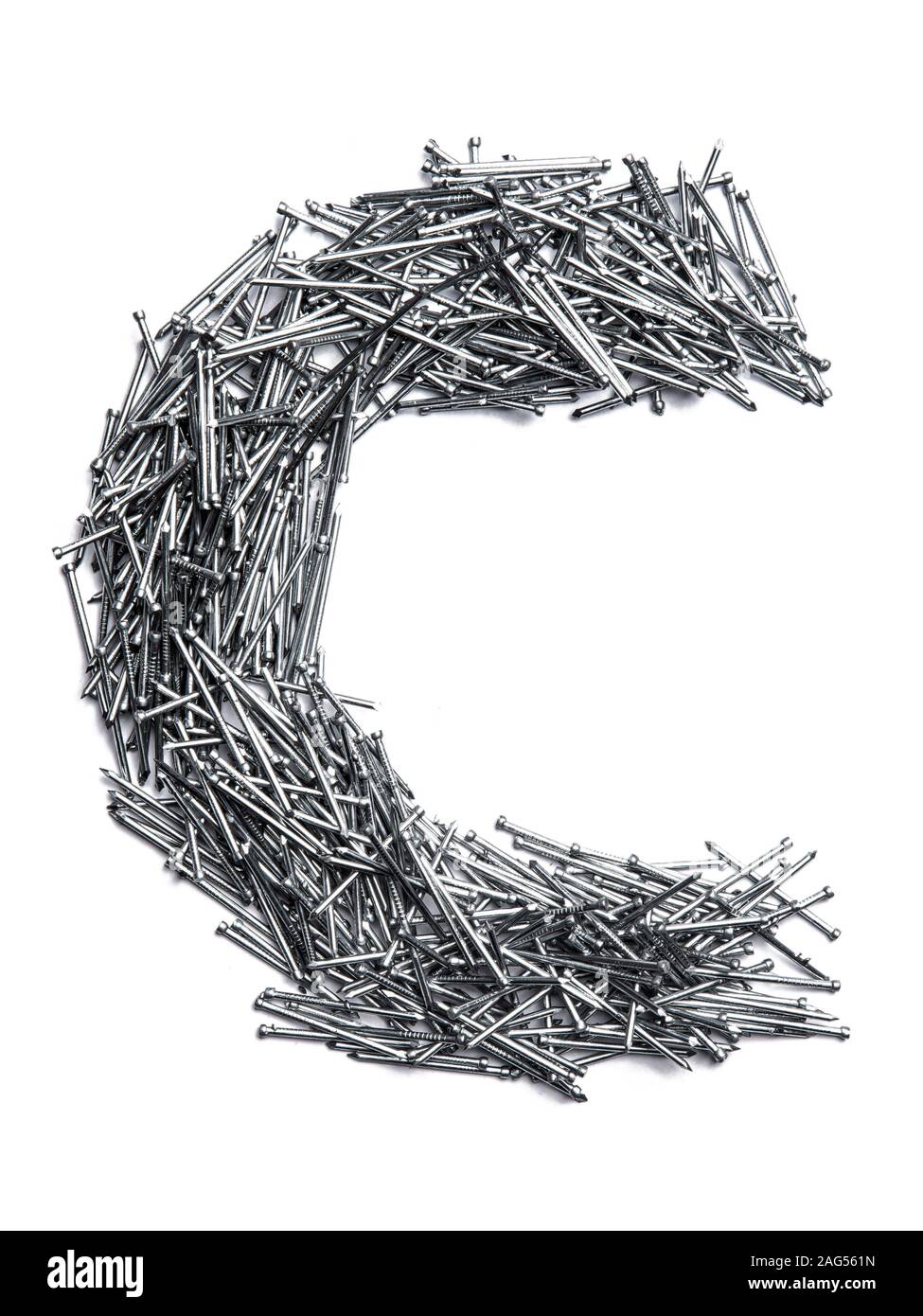 Letter C of the English alphabet from small iron nails on a white ...