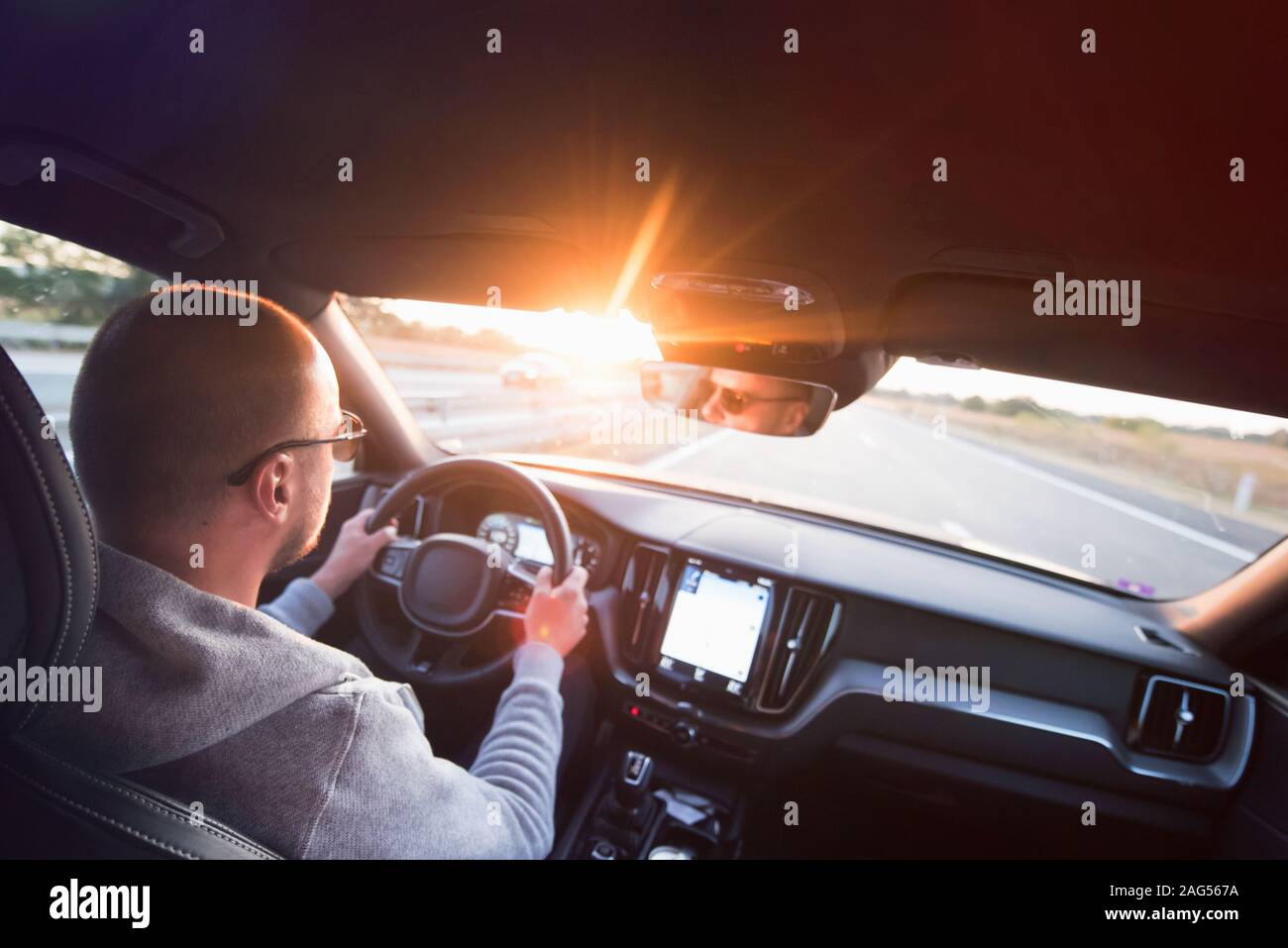 Man driving a car. Success in motion. Handsome young man driving a car ...