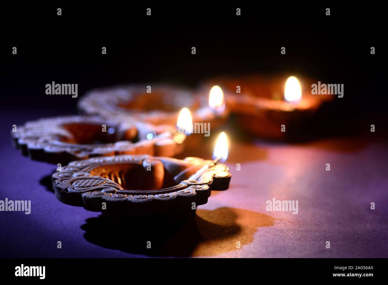 Colorful clay Diya (Lantern) lamps lit during Diwali celebration ...