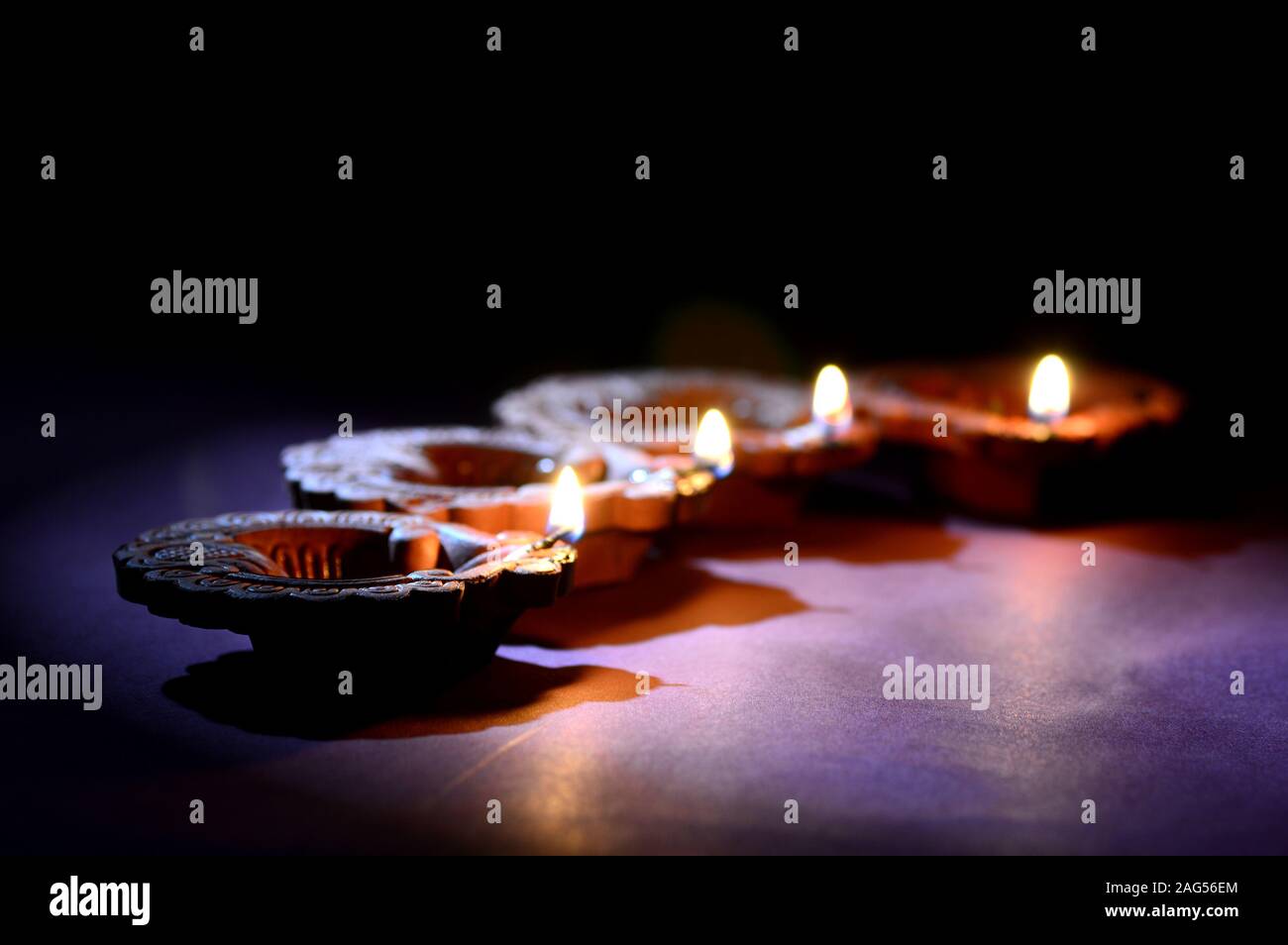 Colorful clay Diya (Lantern) lamps lit during Diwali celebration ...