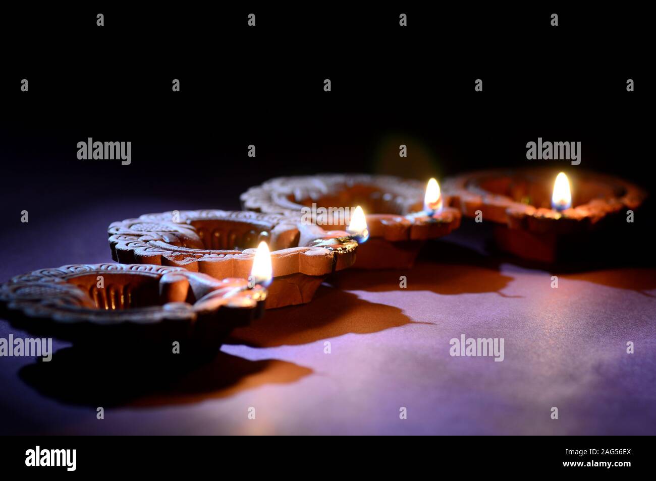 Colorful clay Diya (Lantern) lamps lit during Diwali celebration ...