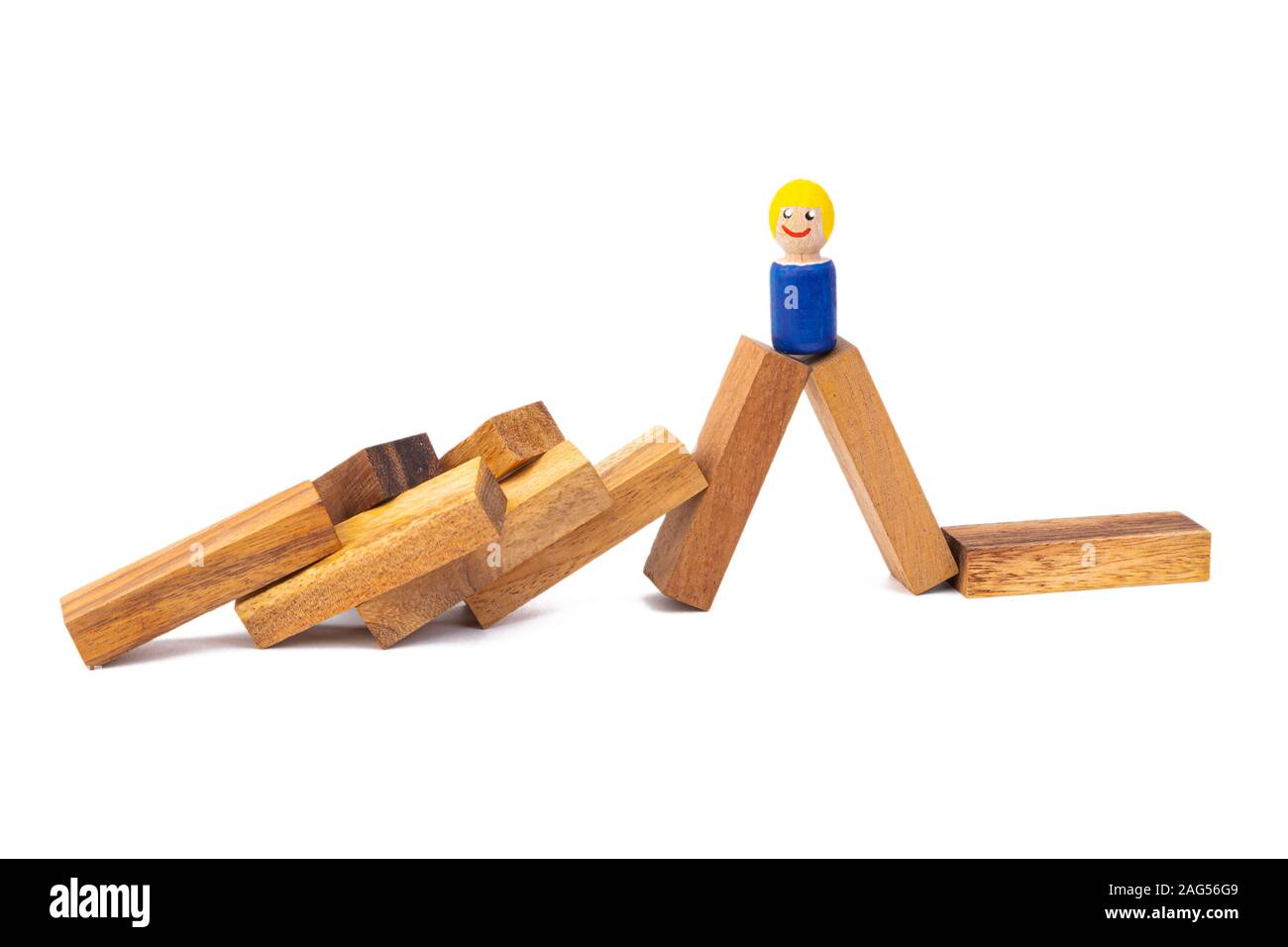 a small wooden toy a boy stands on a large number of wooden chippers on ...