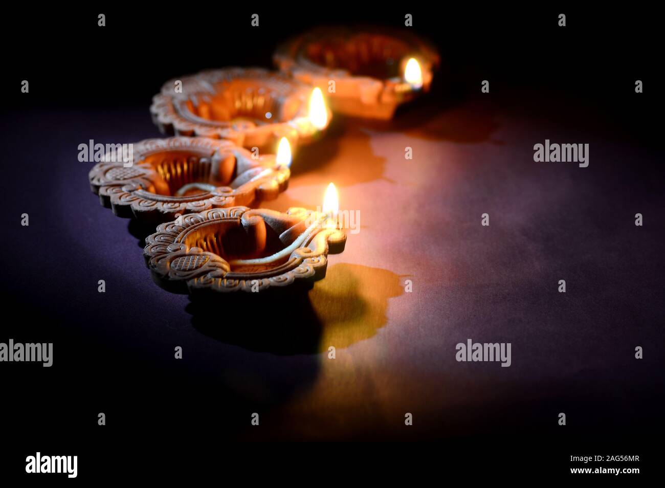 Colorful clay Diya (Lantern) lamps lit during Diwali celebration ...