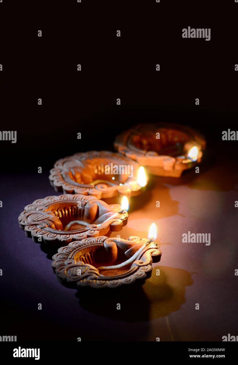 Colorful clay Diya (Lantern) lamps lit during Diwali celebration ...