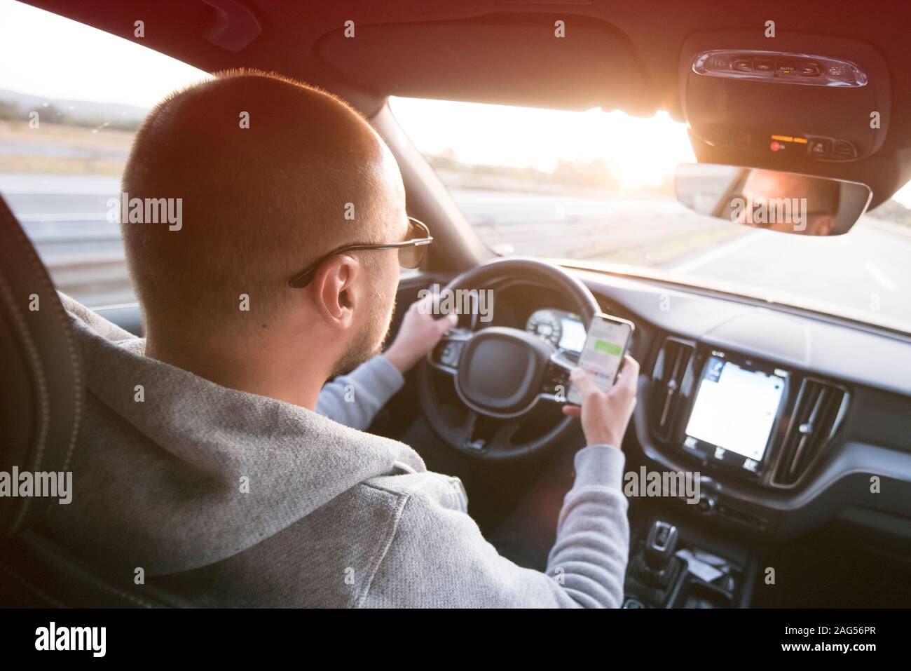 Man driving car using mobile phone texting message or calling. Driver ...