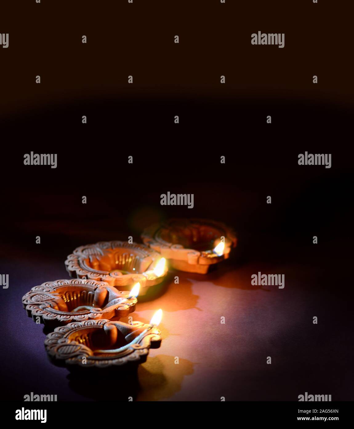 Colorful clay Diya (Lantern) lamps lit during Diwali celebration ...
