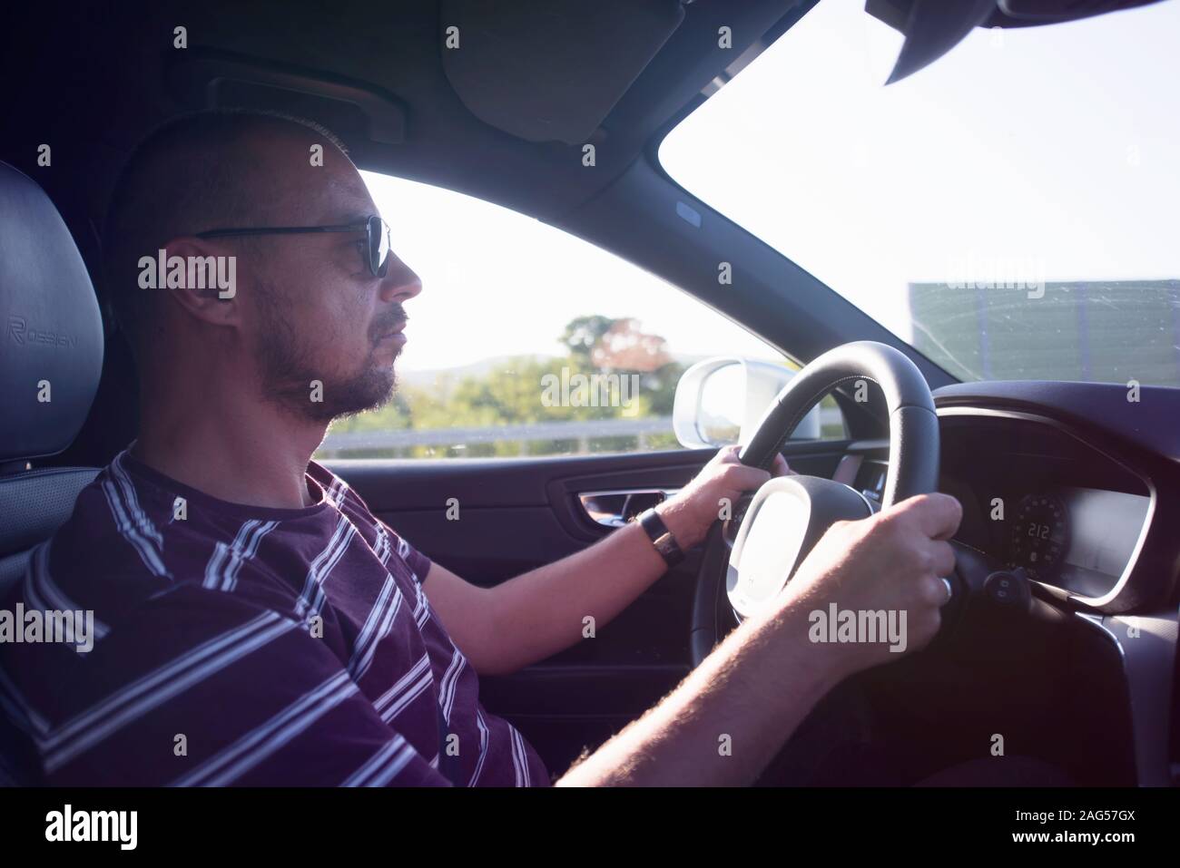 Man driving a car. Success in motion. Handsome young man driving a car ...