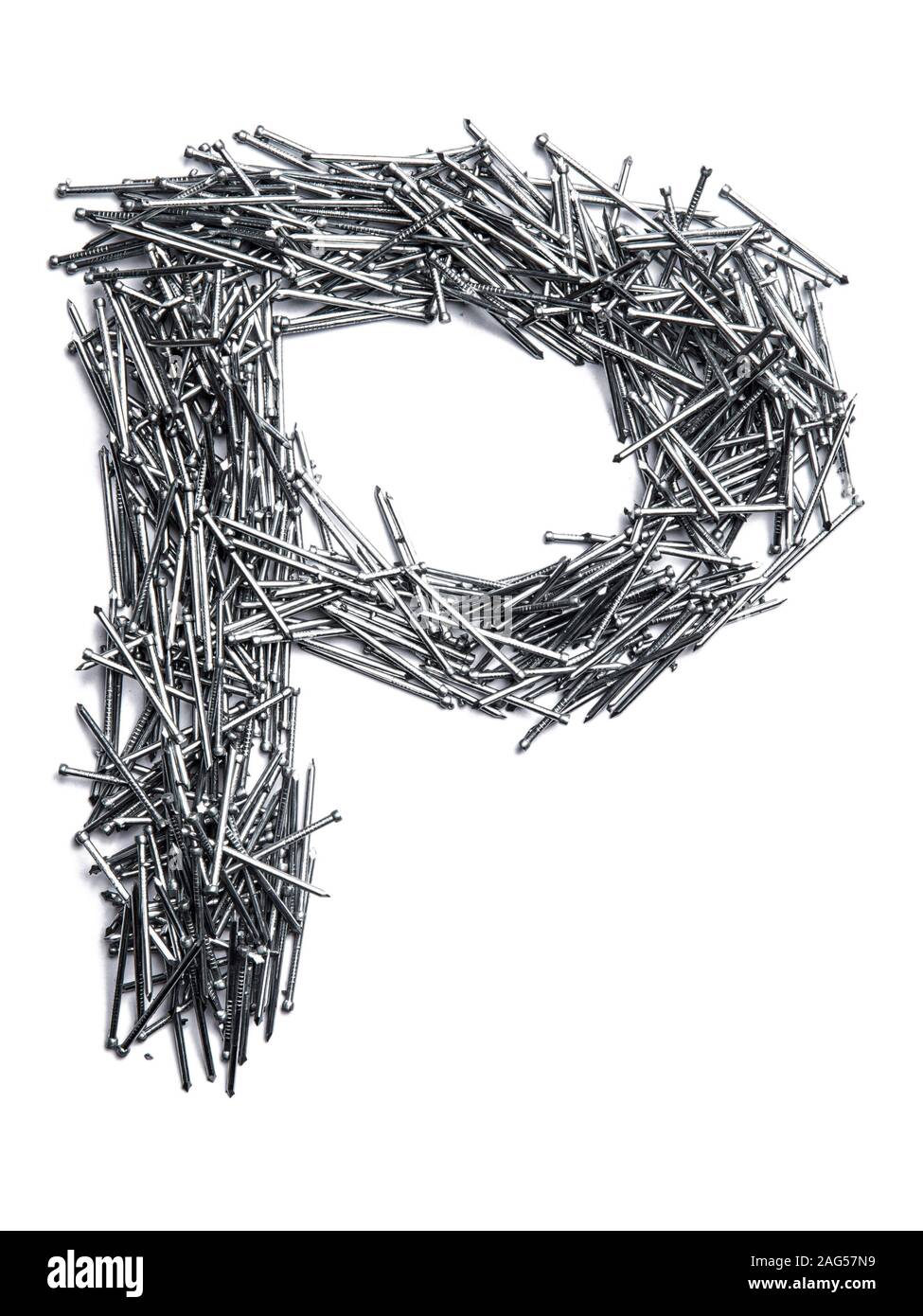 Letter P of the English alphabet from small iron nails on a white ...