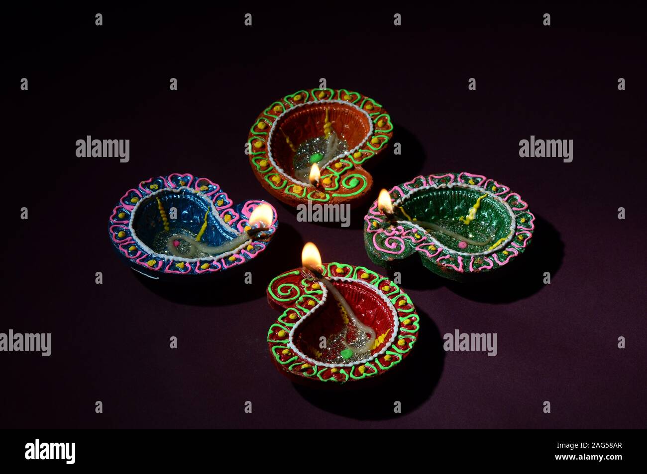 Colorful clay Diya (Lantern) lamps lit during Diwali celebration ...