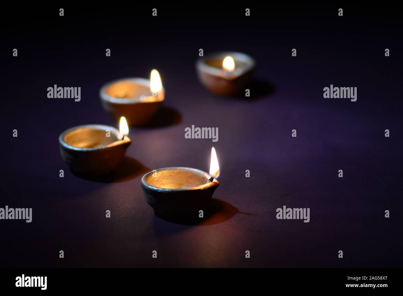 Colorful clay Diya (Lantern) lamps lit during Diwali celebration ...