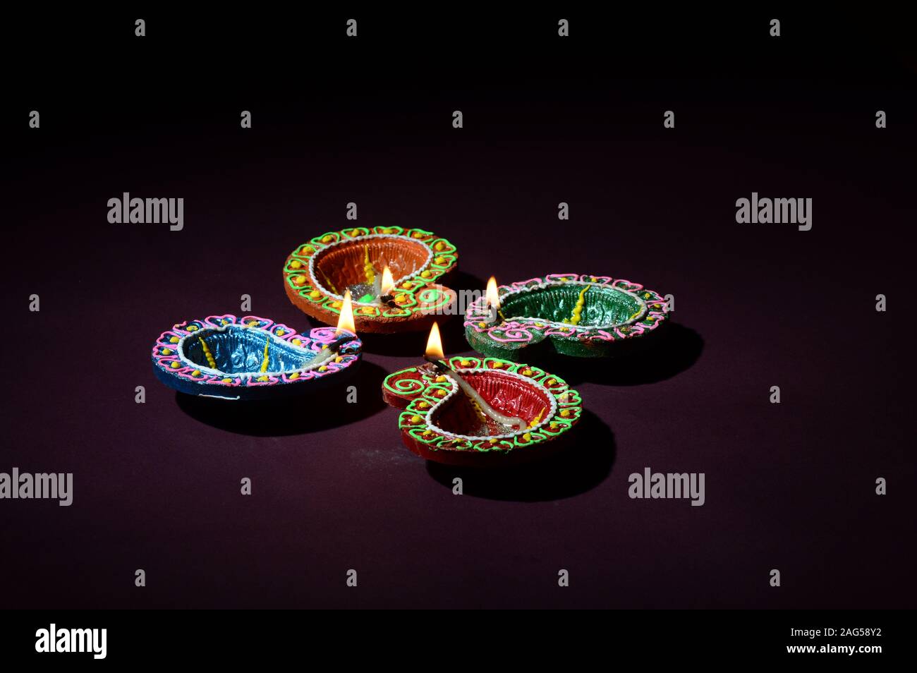 Colorful clay Diya (Lantern) lamps lit during Diwali celebration ...
