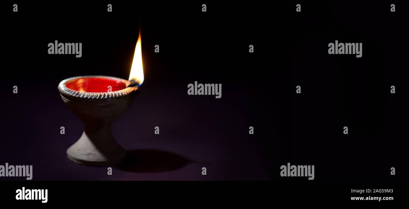 Colorful clay Diya (Lantern) lamps lit during Diwali celebration ...