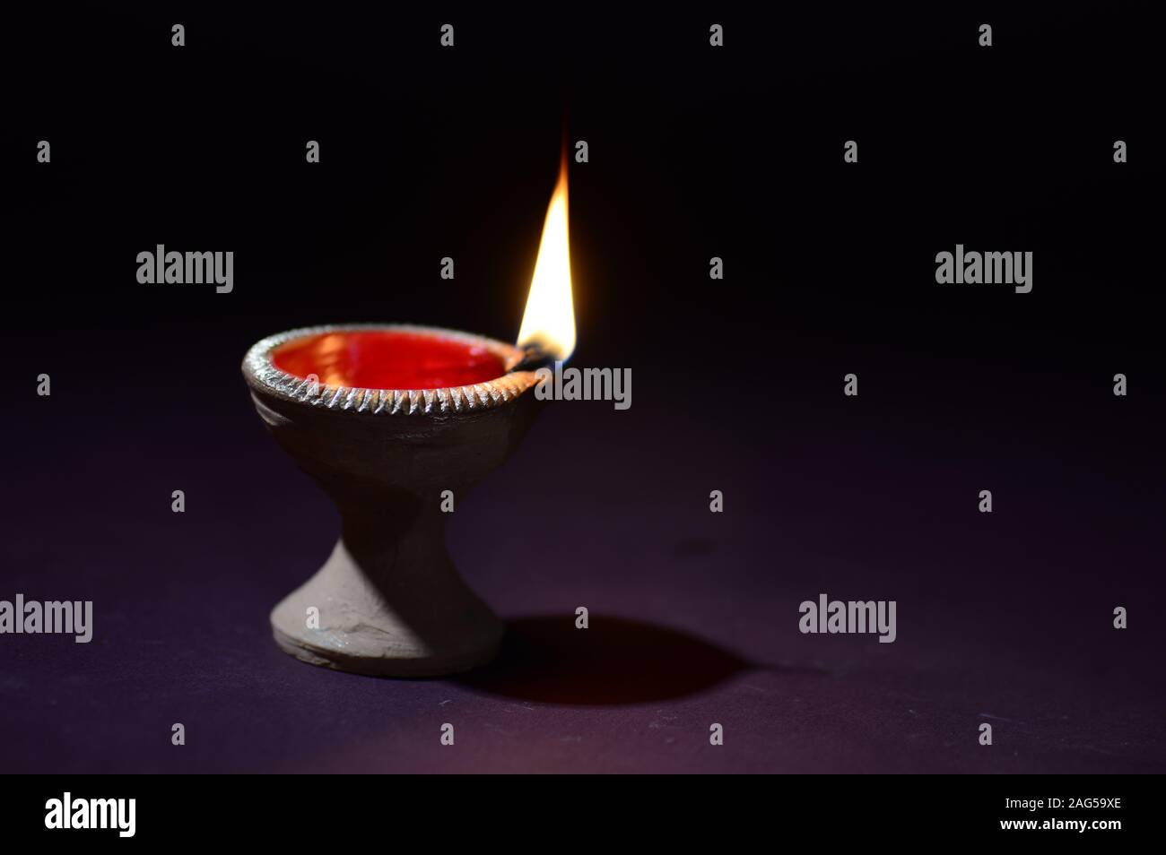 Colorful clay Diya (Lantern) lamps lit during Diwali celebration ...