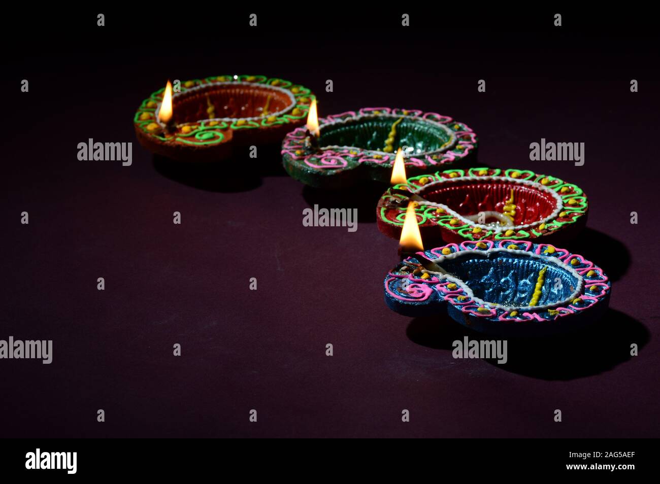 Colorful clay Diya (Lantern) lamps lit during Diwali celebration ...