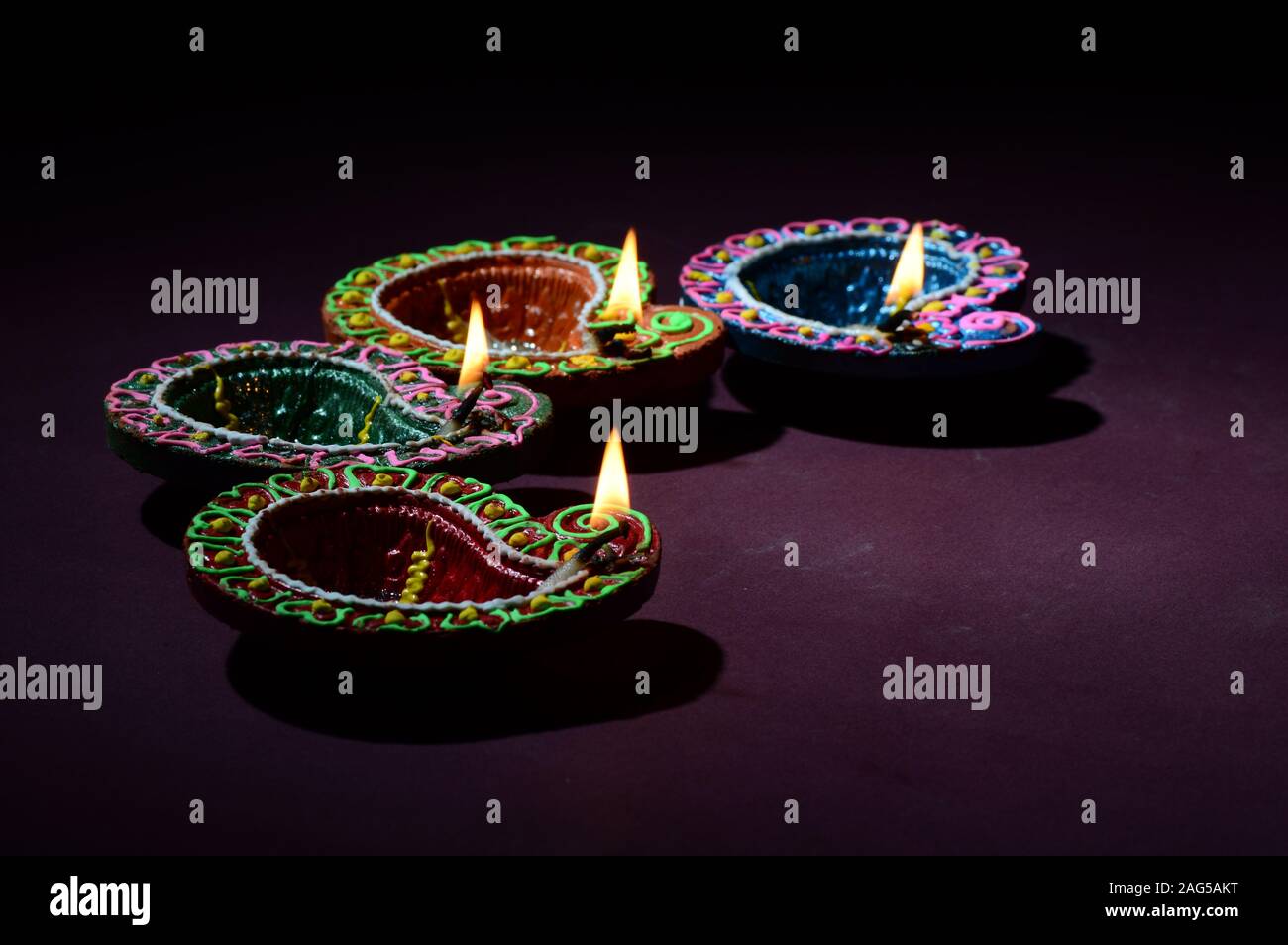 Colorful clay Diya (Lantern) lamps lit during Diwali celebration ...