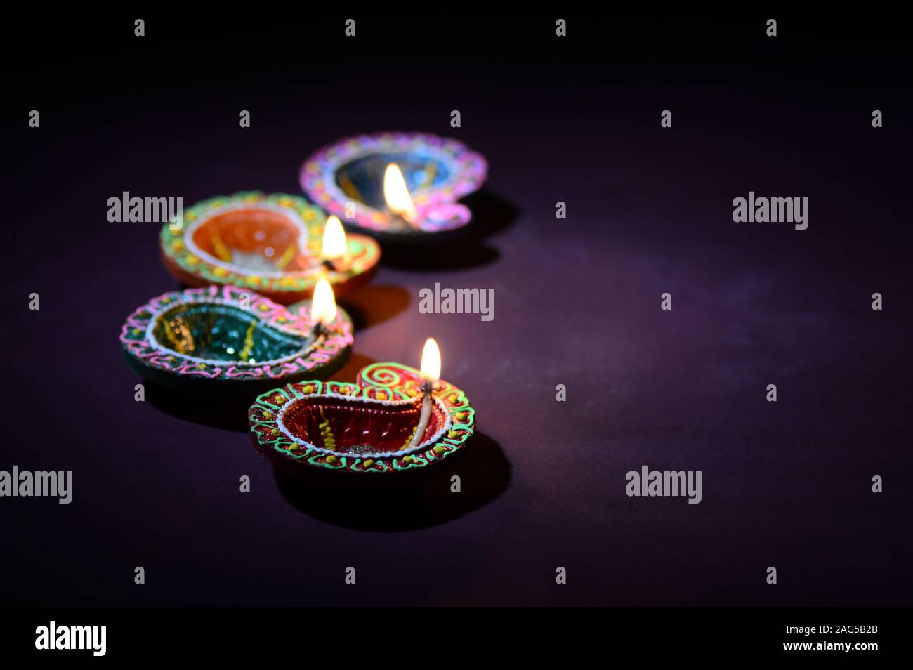 Colorful clay Diya (Lantern) lamps lit during Diwali celebration ...