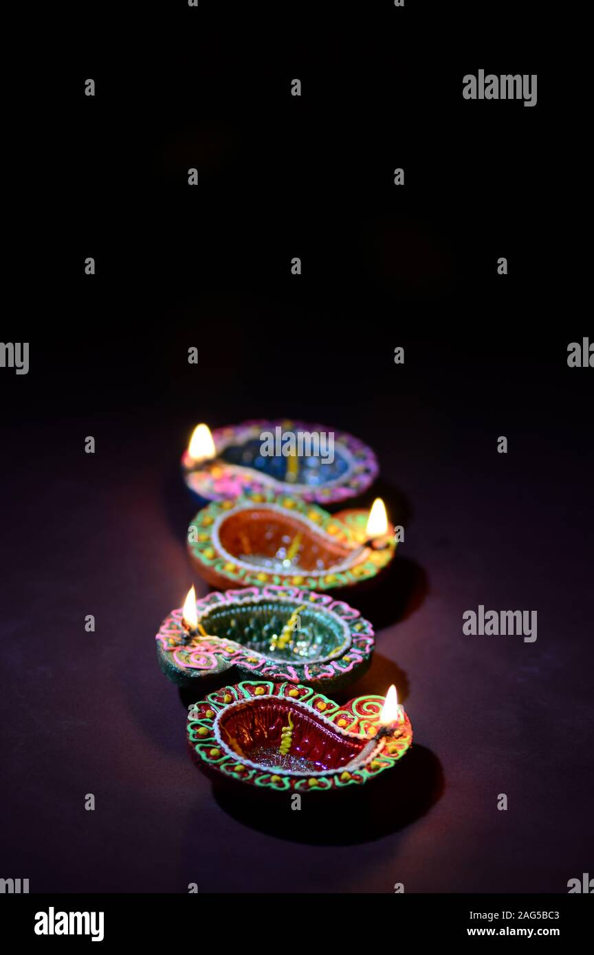 Colorful clay Diya (Lantern) lamps lit during Diwali celebration ...
