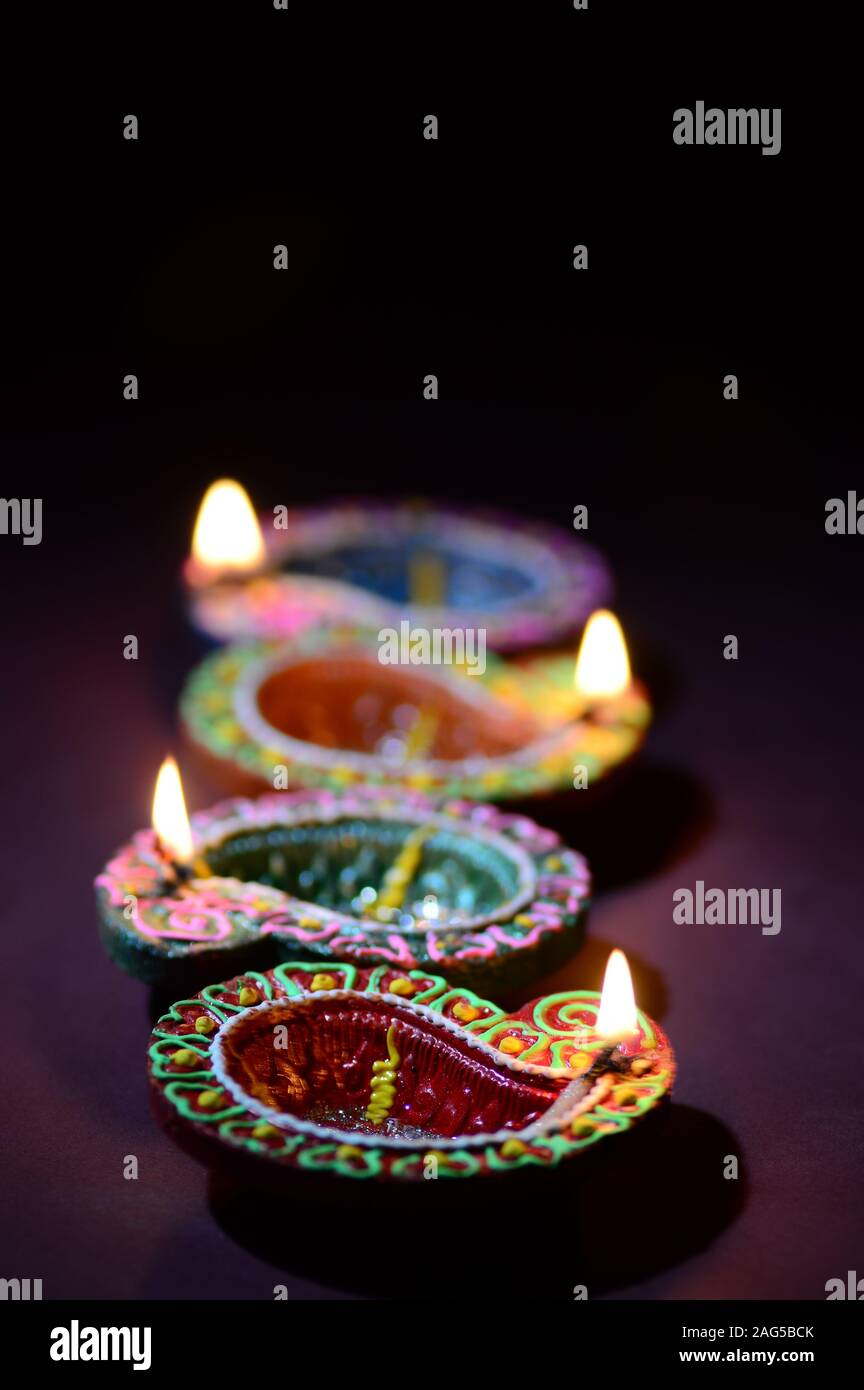 Colorful clay Diya (Lantern) lamps lit during Diwali celebration ...