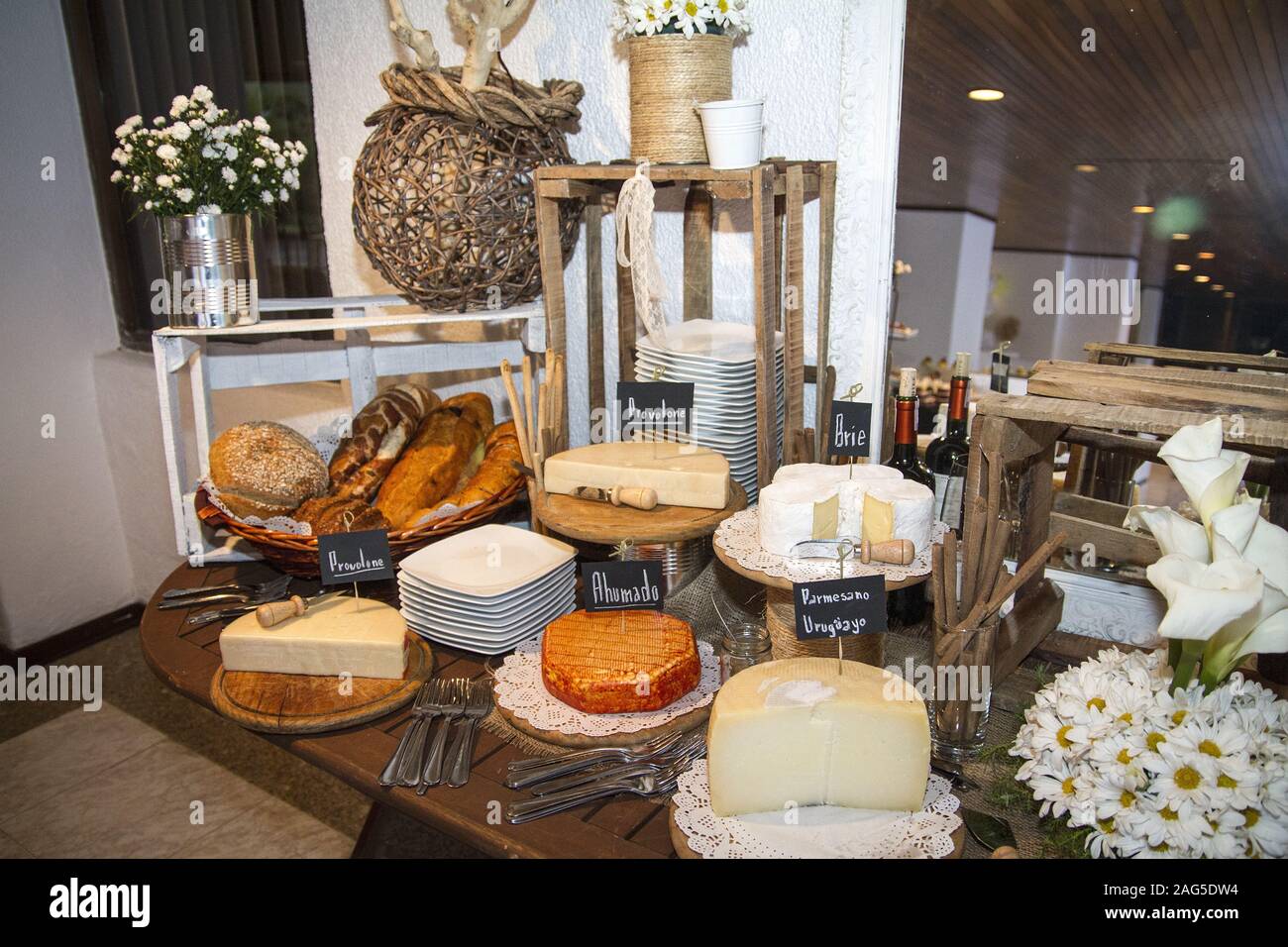 Table full of different kinds of cheese and bread in a shop Stock Photo ...