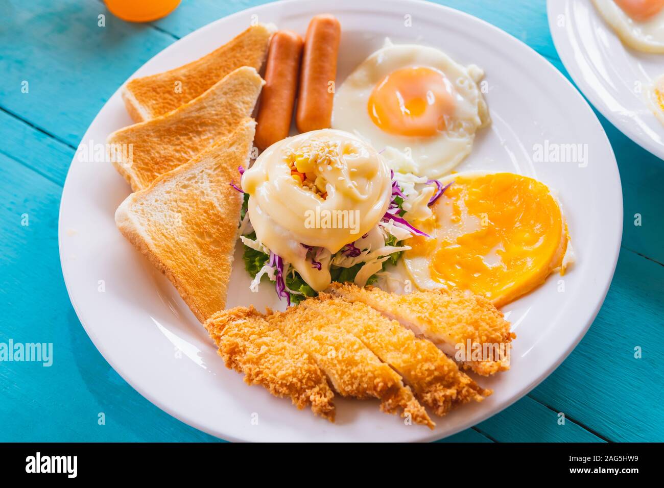 English breakfast - toast, egg, bacon and vegetables on blue wood table ...