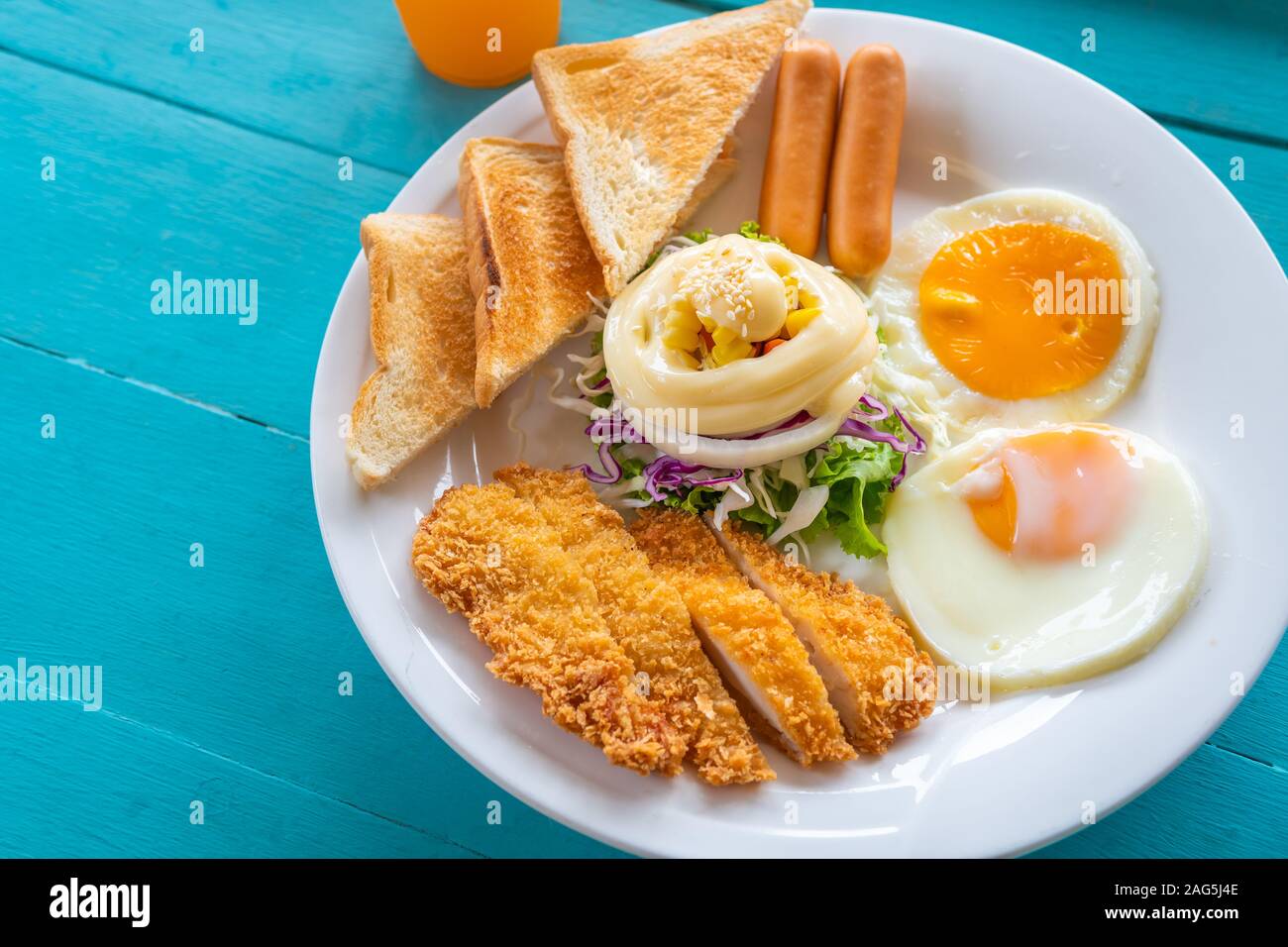 English breakfast - toast, egg, bacon and vegetables on blue wood table ...