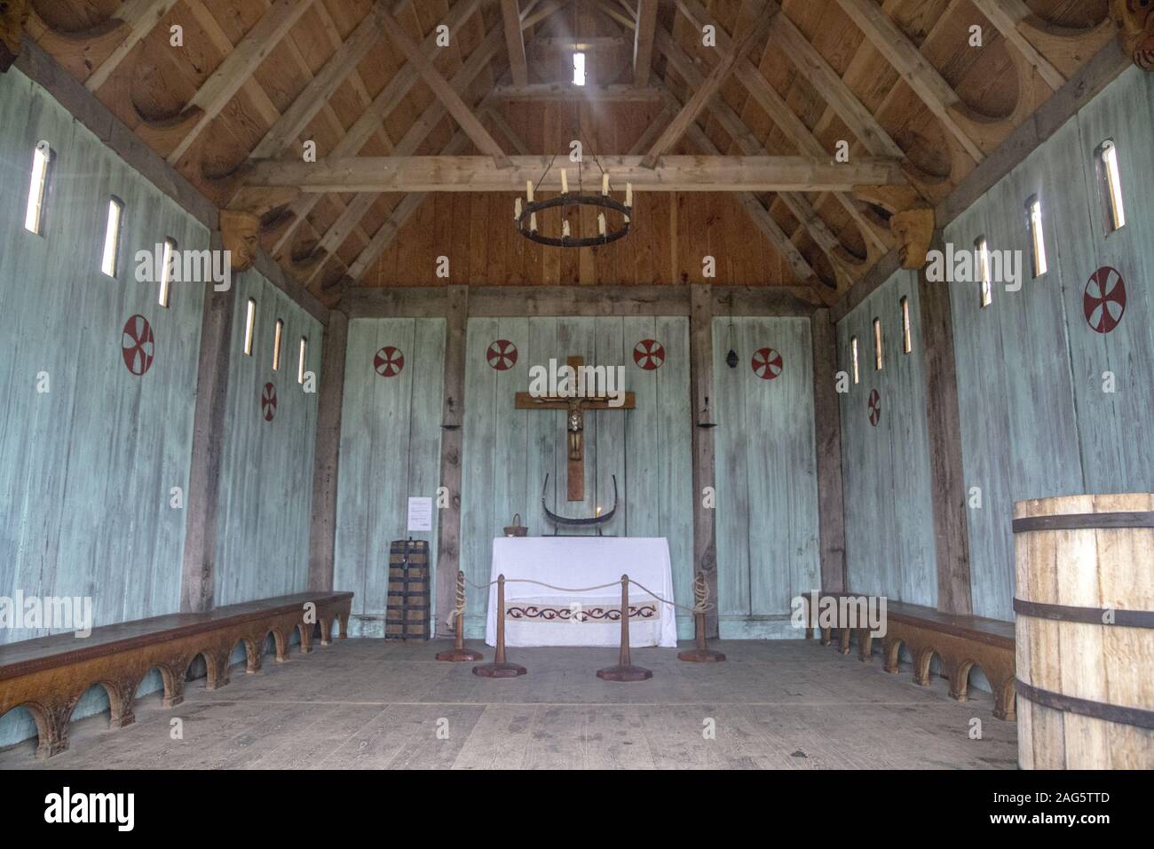Inside of a wooden chapel in a Viking village with blue and brown walls ...