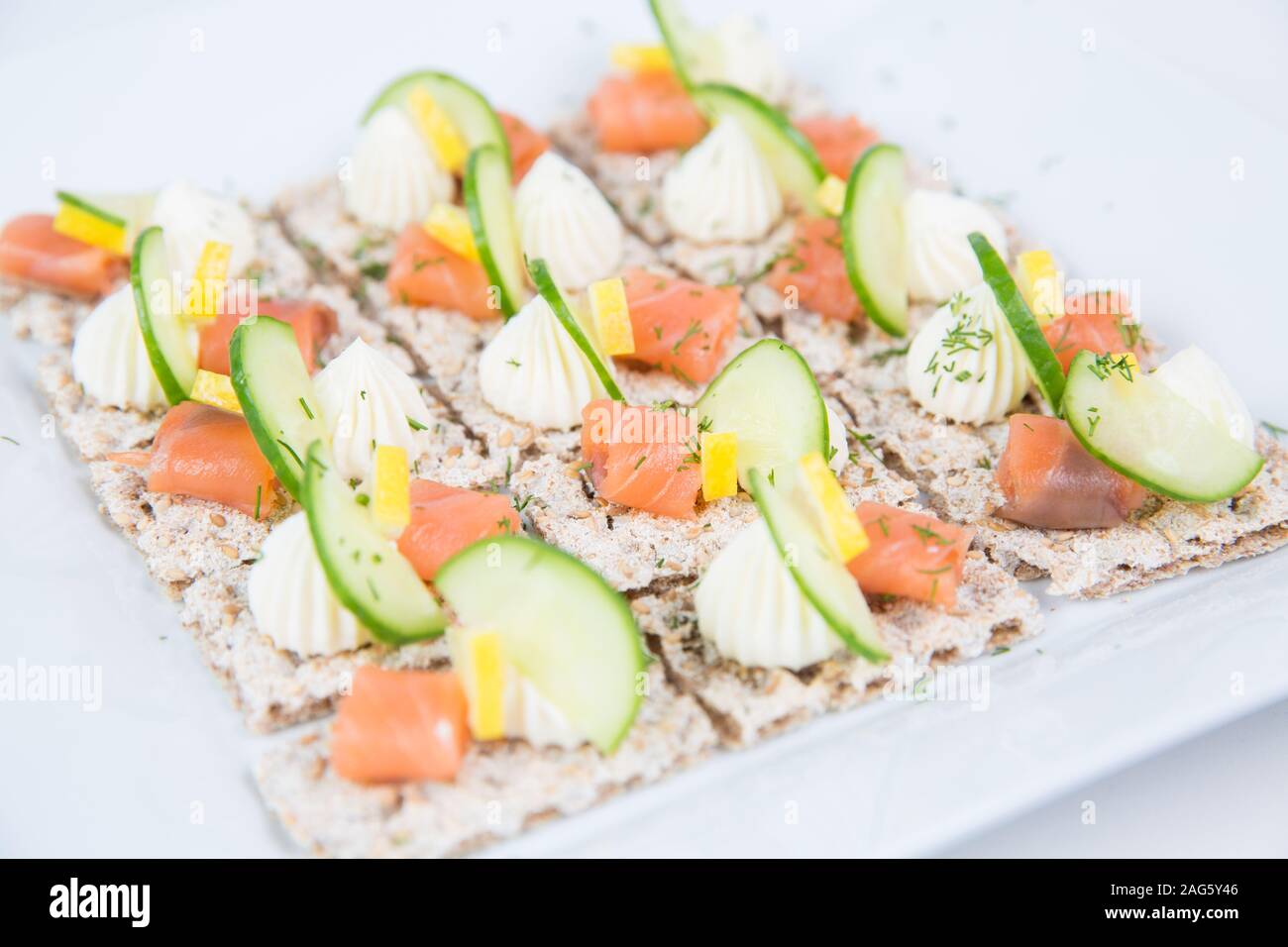 High angle shot of fish canapes in a white ceramic plate isolated on a ...