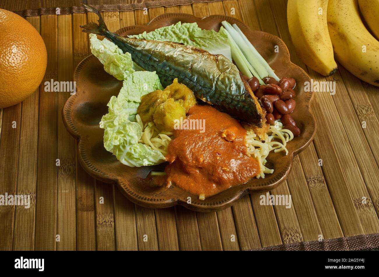 Kenkey with fried fish and chili pepper, Ghanaian cuisine, Traditional assorted African dishes ...
