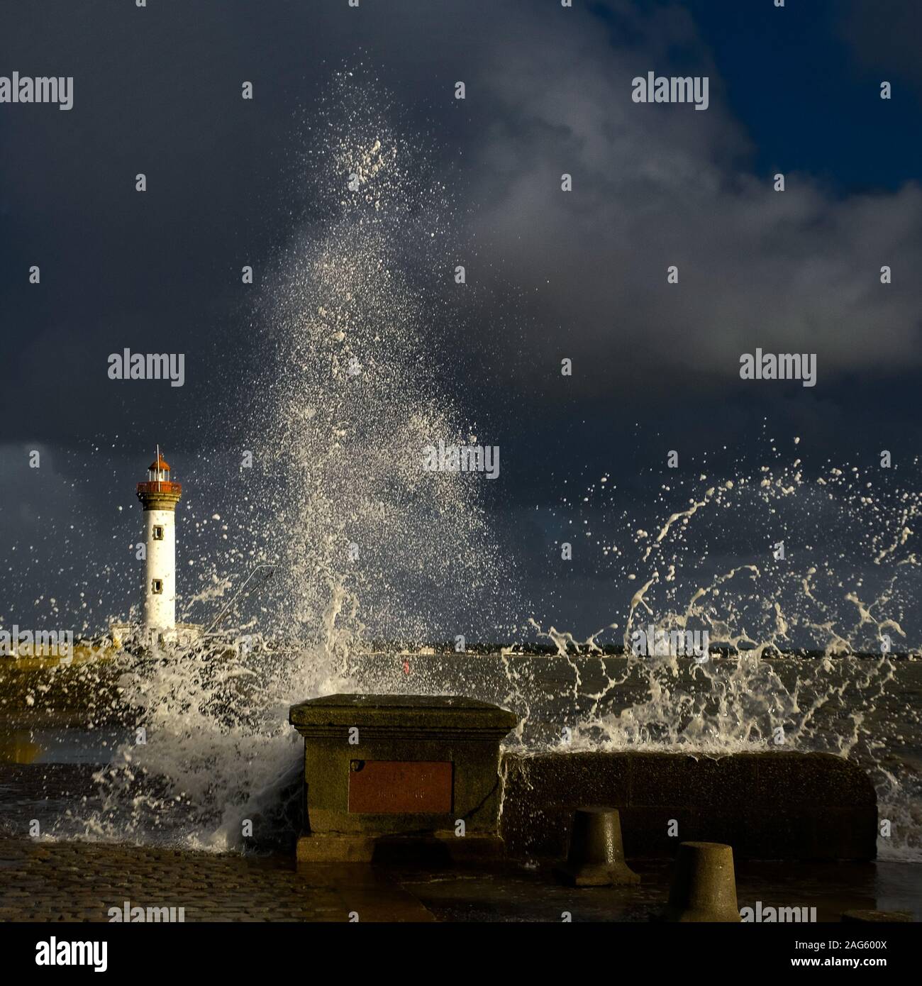 Fresh splash of water next to a lighthouse under the gloomy sky Stock ...