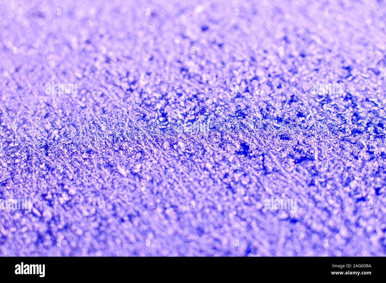 Texture of sparkling first cold ice. Snowy backdrop in purple colors ...