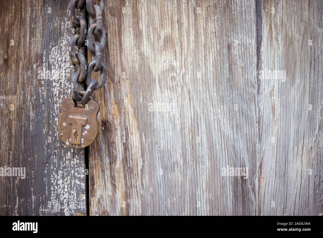 Beautiful closeup shot of an old wooden gate with a rust iron lock and ...
