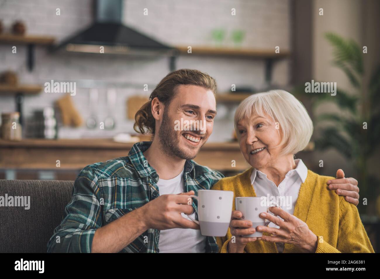 In the morning. Grey-haired elderly woman having morning coffee with ...