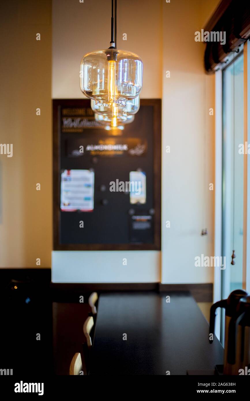 Vertical interior shot of a cafe lights hanging from the ceiling with a ...