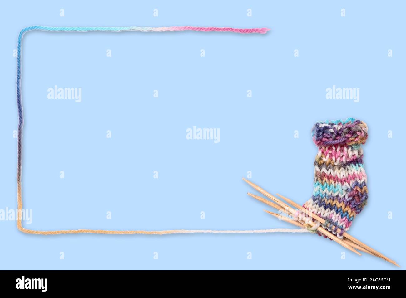 Little knitted sock with frame, its a boy Stock Photo - Alamy