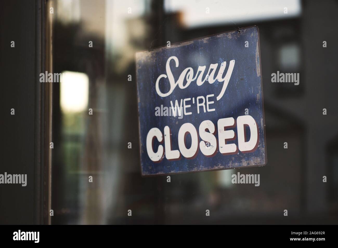 Closeup shot of a blue and white Sorry we are closed wooden signage on ...