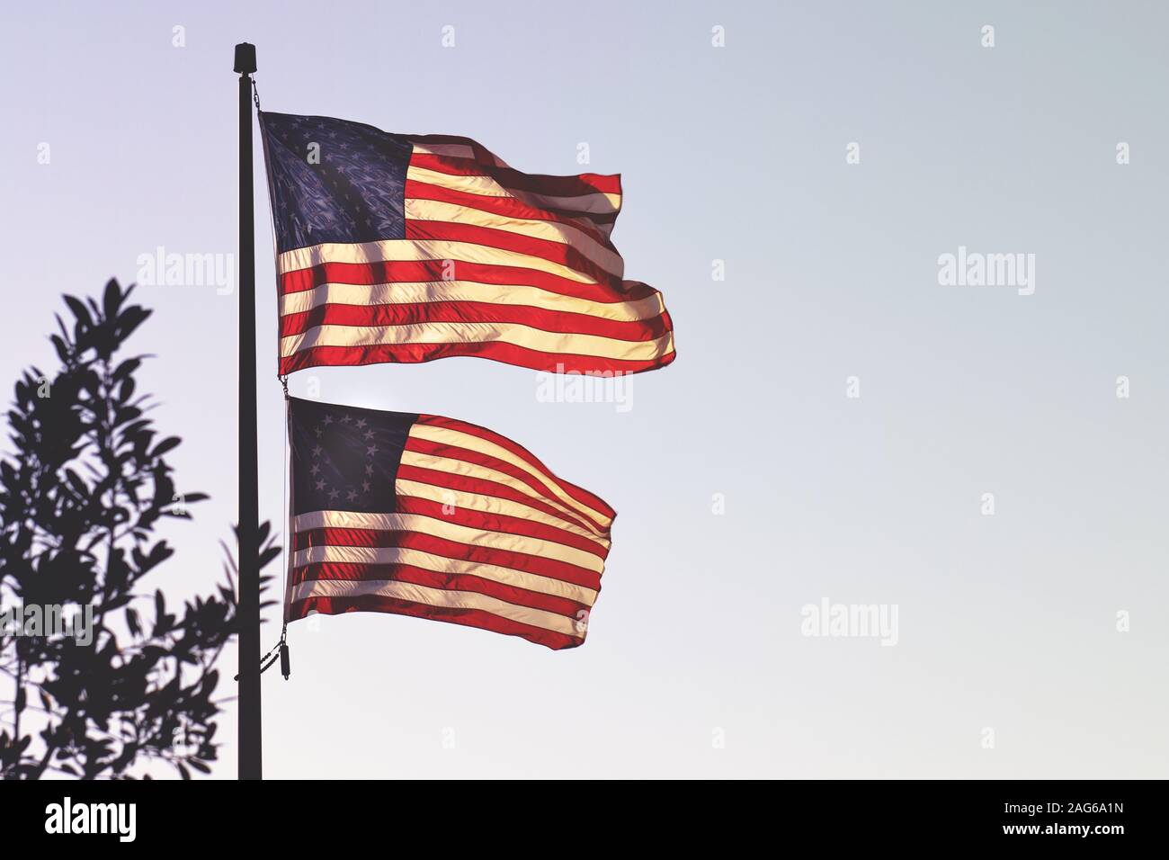 Two flags flying on a single pole hi-res stock photography and images ...