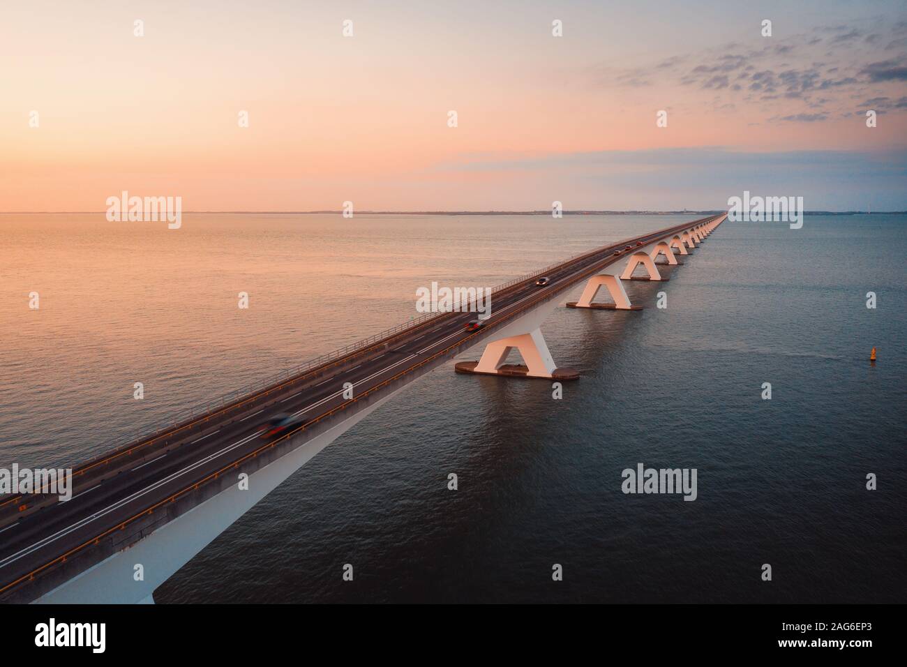 Long bridge going over the magnificent ocean under the beautiful ...