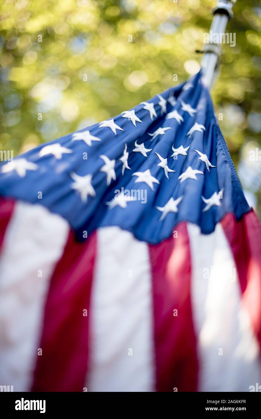 Vertical low angle shot of the united states flag hanging from a pole ...