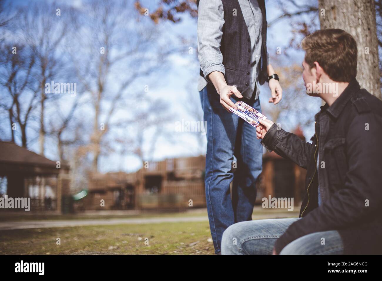 Shallow focus shot of a male giving out pamphlets to people Stock Photo ...
