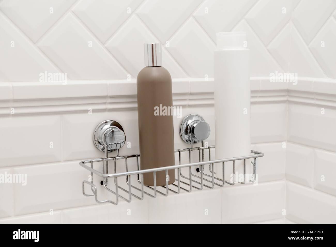 Toiletries bottles on suction cups compact bath shelf, fixing on tiled ...