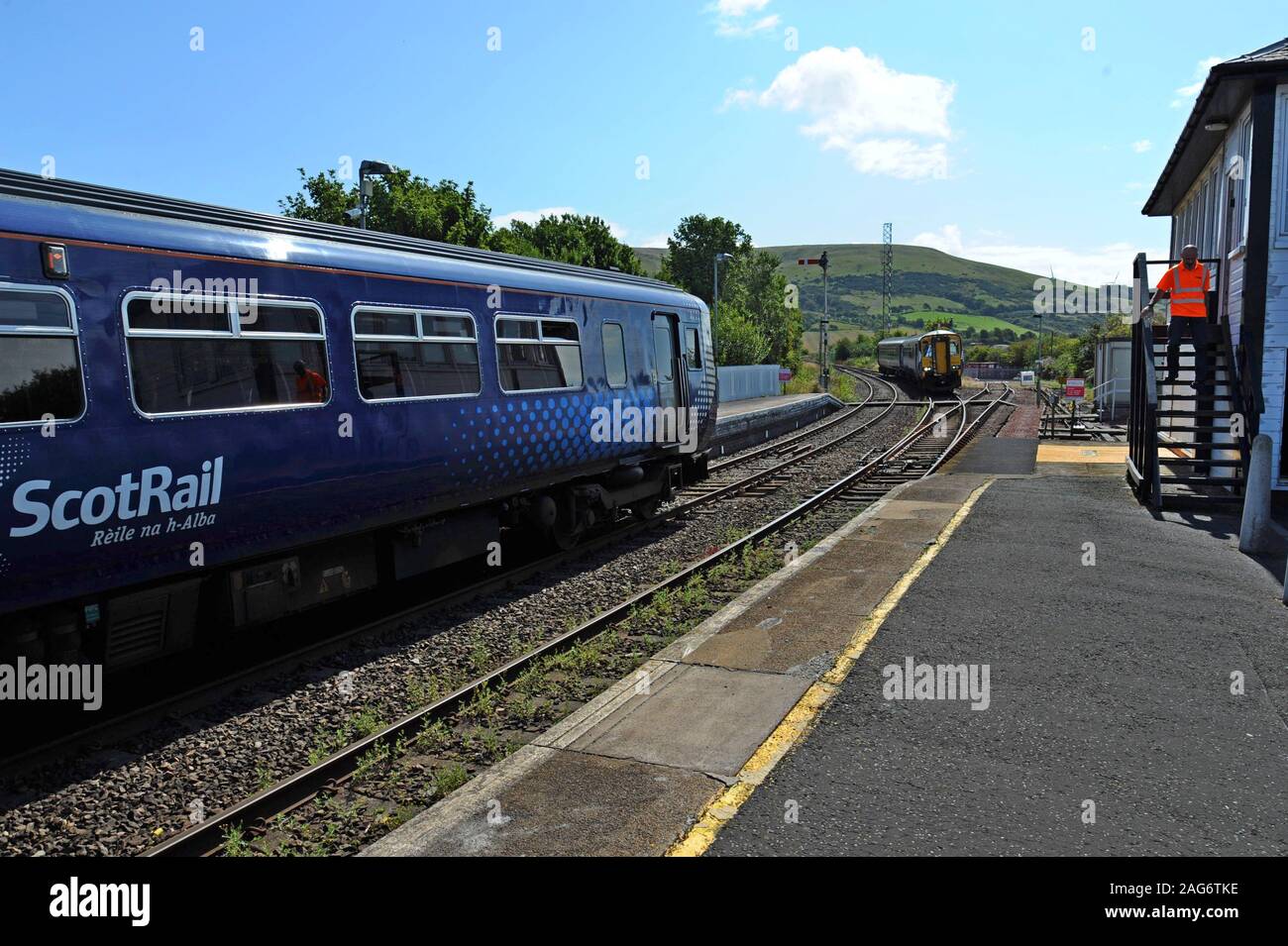 A signalman and train driver exchanging the single line working token ...