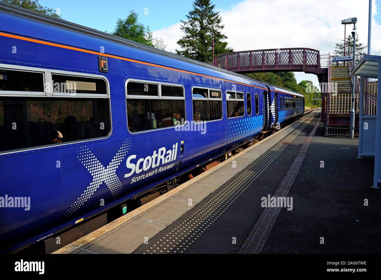 A Scotrail train seen under the footbridge at Maybole Station, Ayrshire ...