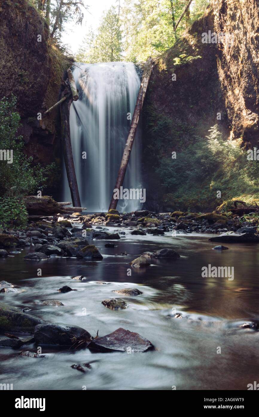Vertical low angle shot of a beautiful waterfall in the rocks Stock ...