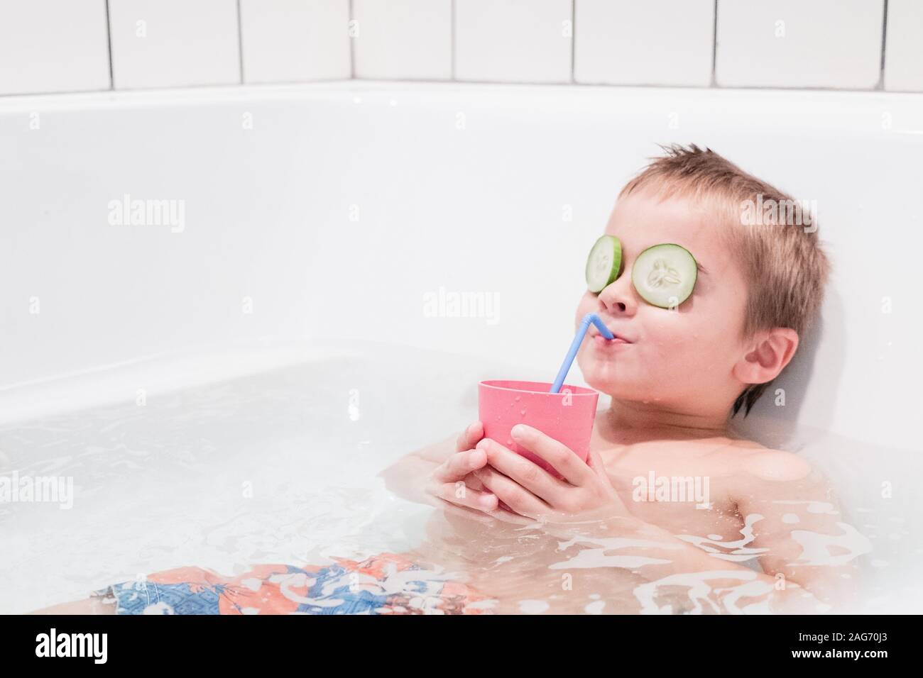 Young happy boy having a calming jacuzzi session in a jacuzzi and ...