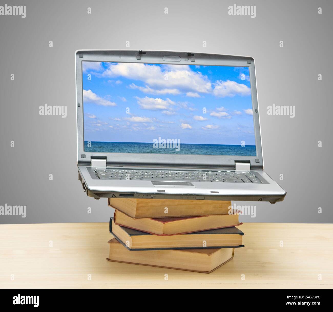 Notebook on pile of books Stock Photo - Alamy