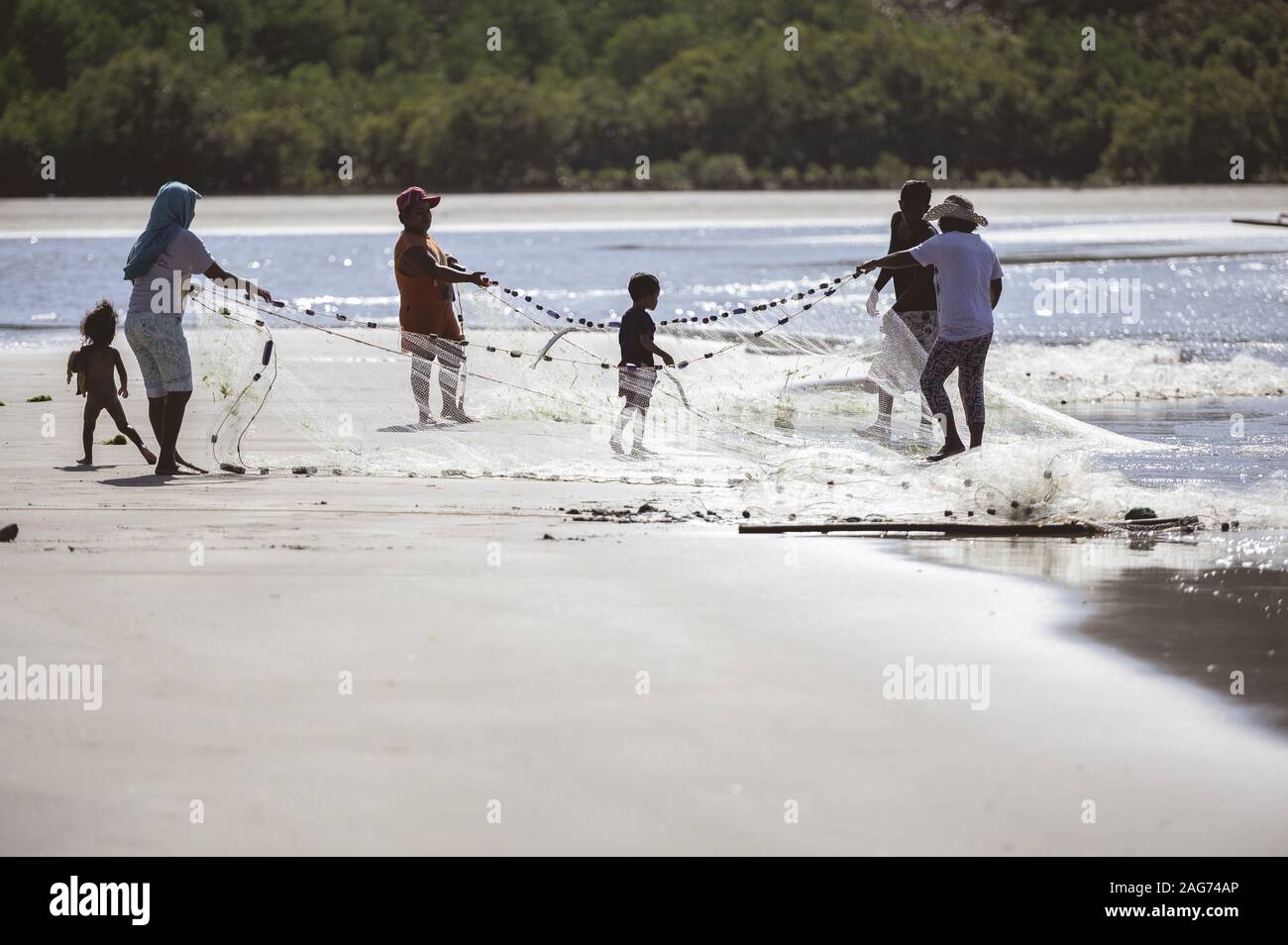 MANILA, PHILIPPINES - Nov 11, 2019: Group of people fishing with a net ...