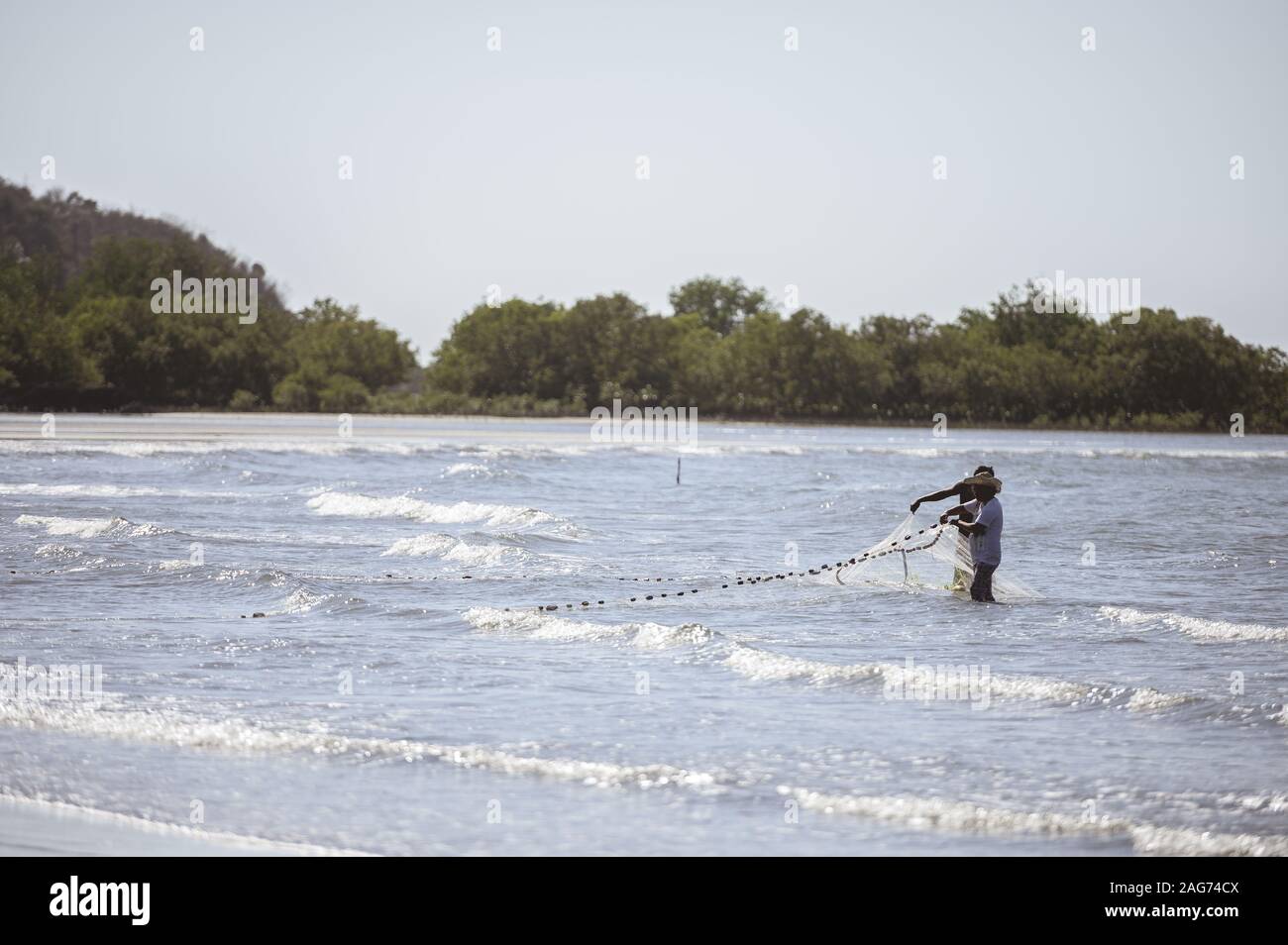 MANILA, PHILIPPINES - Nov 11, 2019: Man fishing with a net in the ...